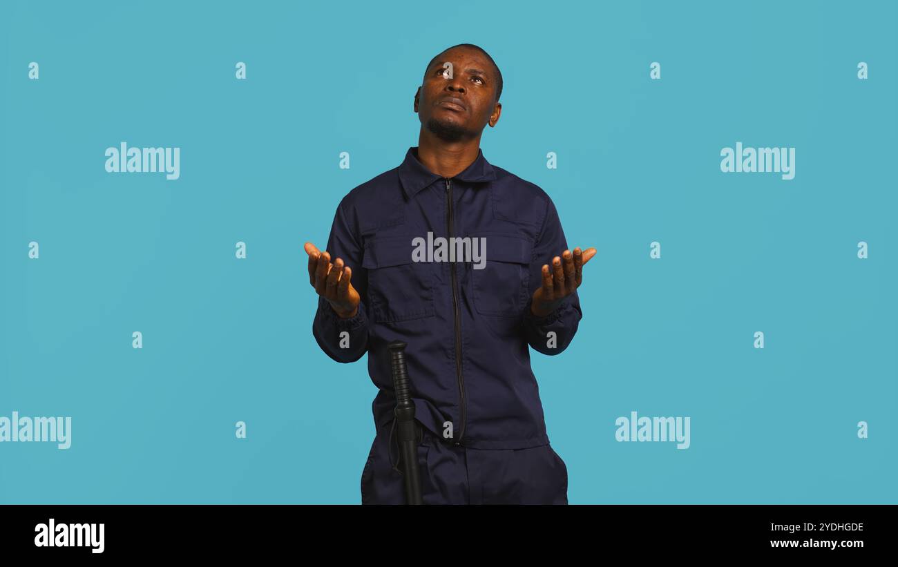 Security guard tasked with restricting unwanted access looking to sky ...