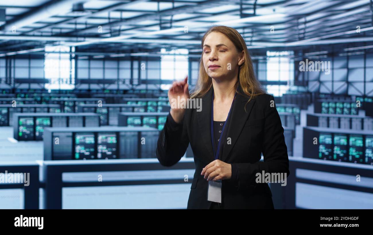 Software developer looking at holograms in data center, monitoring ...