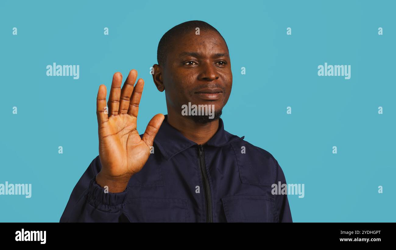 Portrait of security job employee waving hand, being friendly with ...