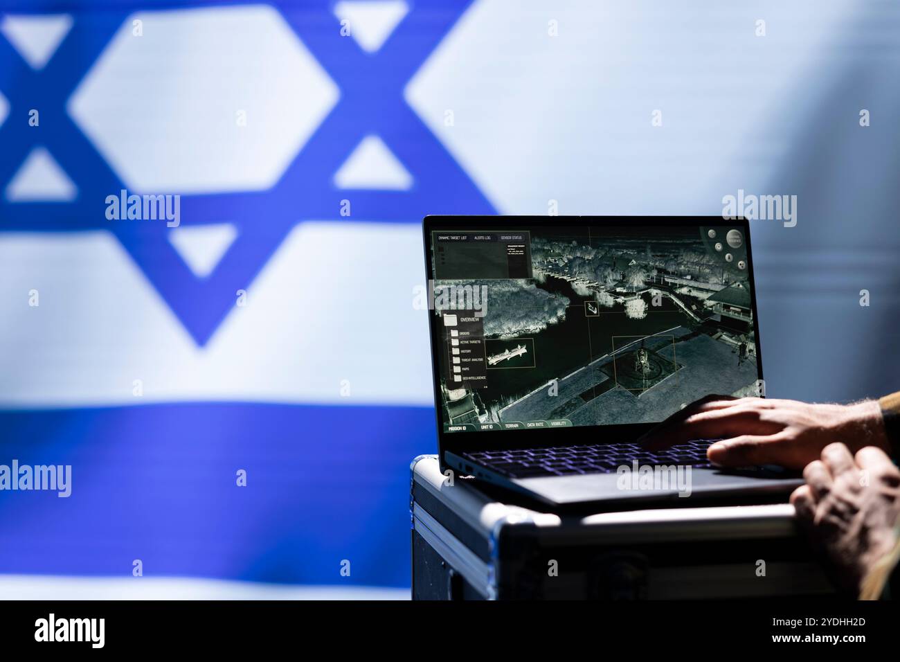 Military operative engaged in surveillance mission using laptop ...