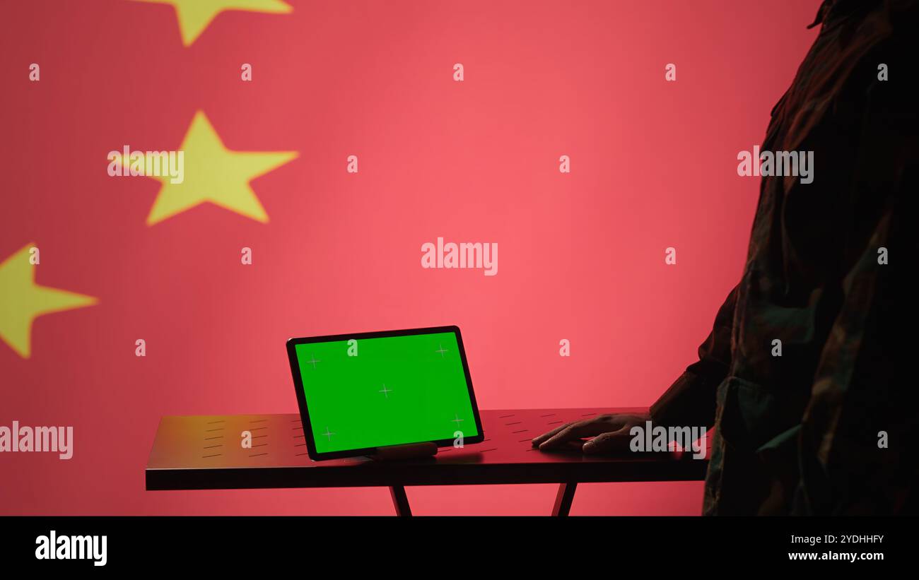 Chinese intelligence agency operator using green screen tablet to do ...