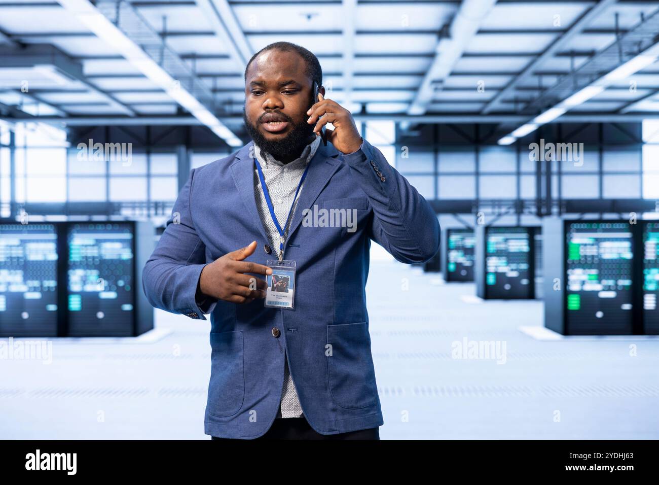 Businessman talking on phone in high tech data center housing advanced ...