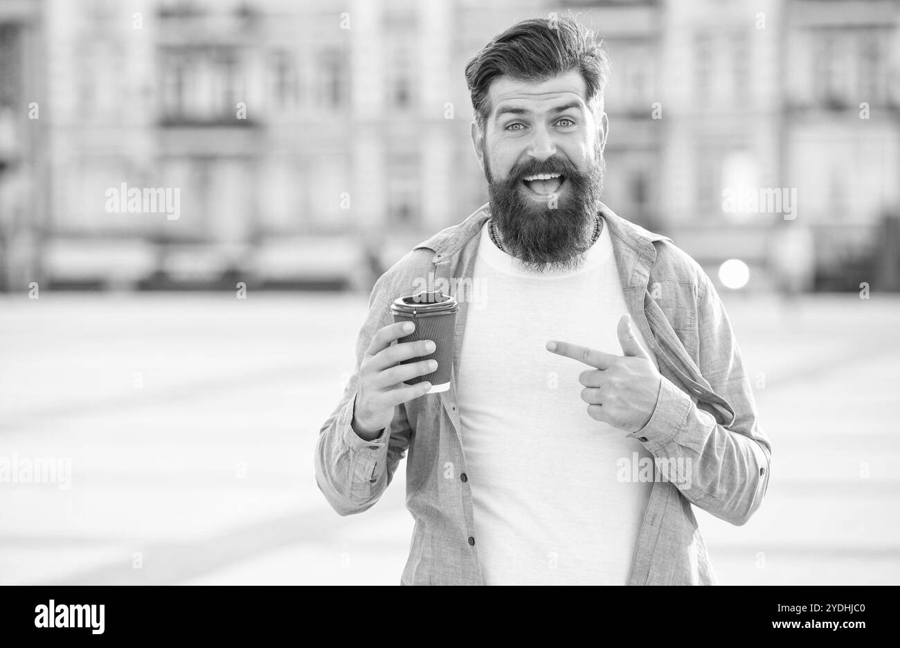 guy offering coffee in the street, pointing finger. photo of guy ...