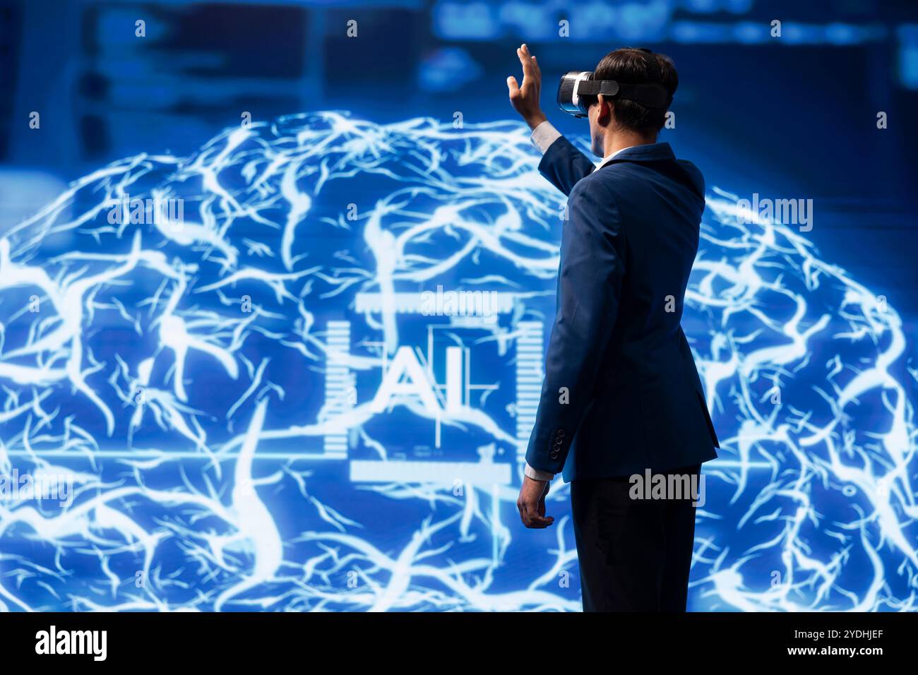 Computer scientist wearing VR headset looking at hologram of artificial ...