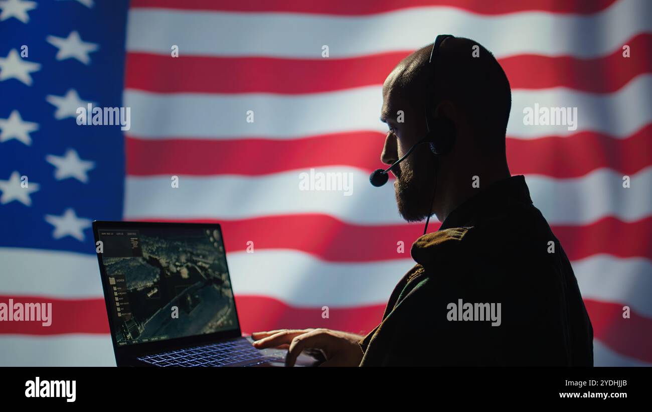 US Air Force dispatcher looking at surveillance transmission on device ...