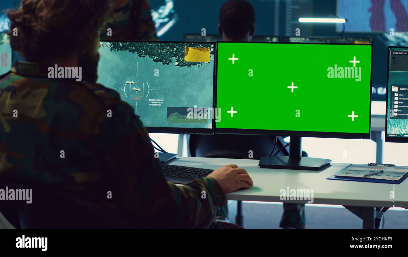 Team of IT military specialists working with a greenscreen on a big ...