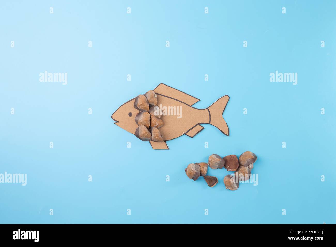 process of making a fish shaped craft using pine cones seed scales, and ...