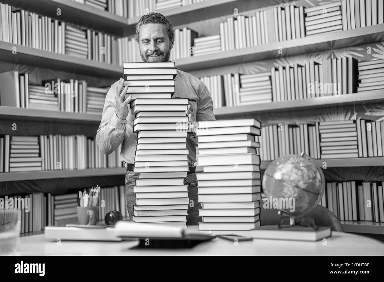 Man with books in library. Knowledge and education. Absorbed in a book ...