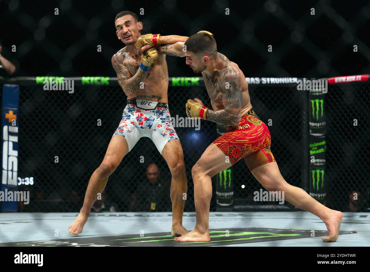 Champion Ilia Topuria, right, battles Max Holloway during a mixed ...