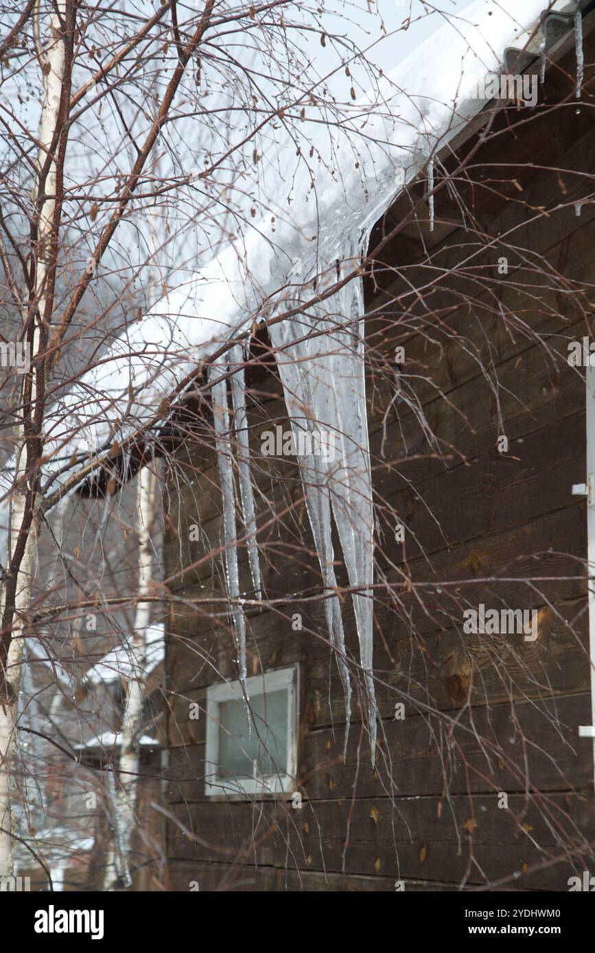 Water droplets are ice dripping from the roof of a house Stock Photo ...