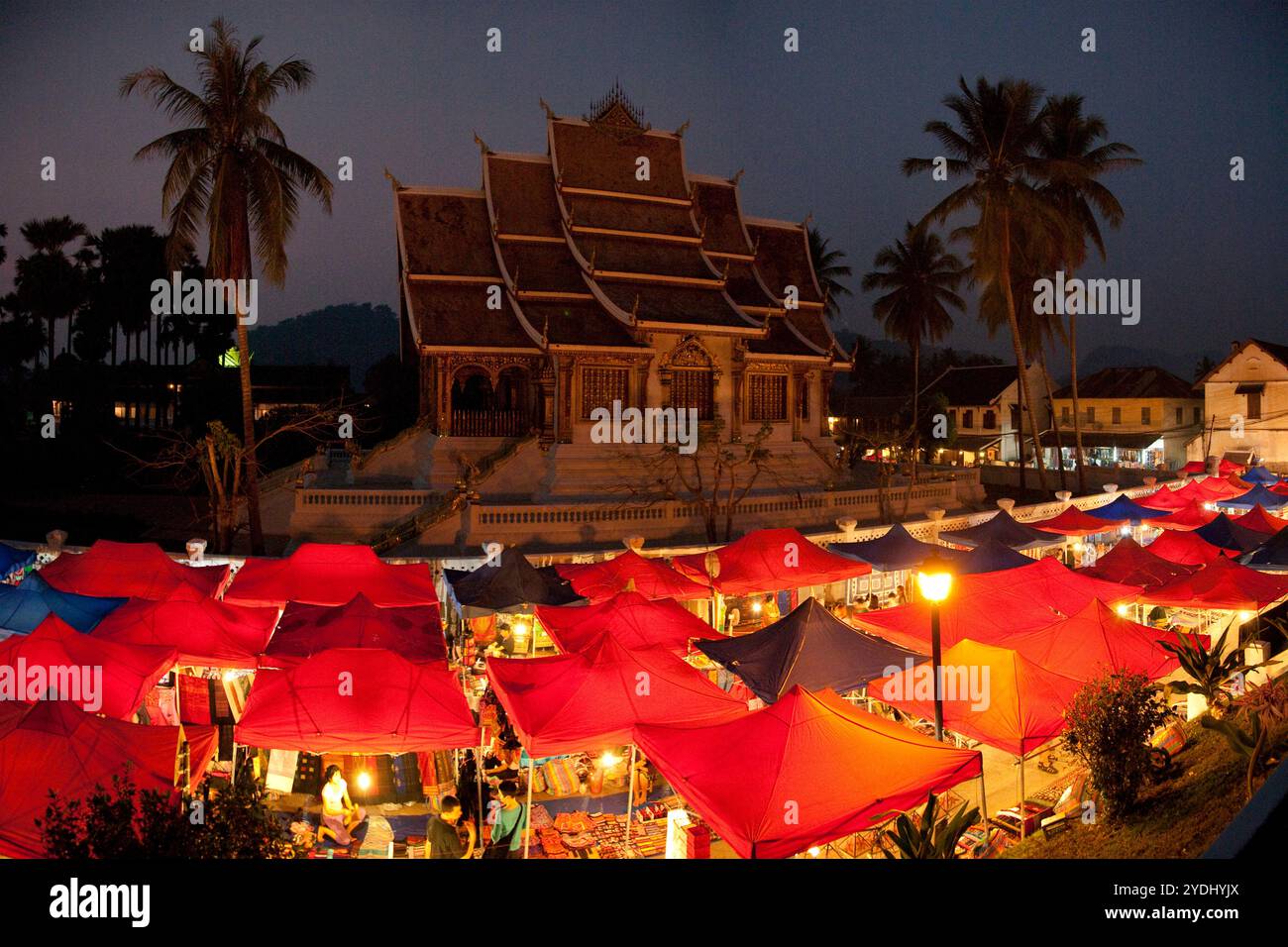 The Hmong night market with Haw Pha Bang temple in the background in ...