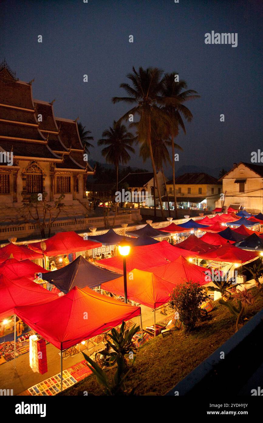The Hmong night market with Haw Pha Bang temple in the background in ...