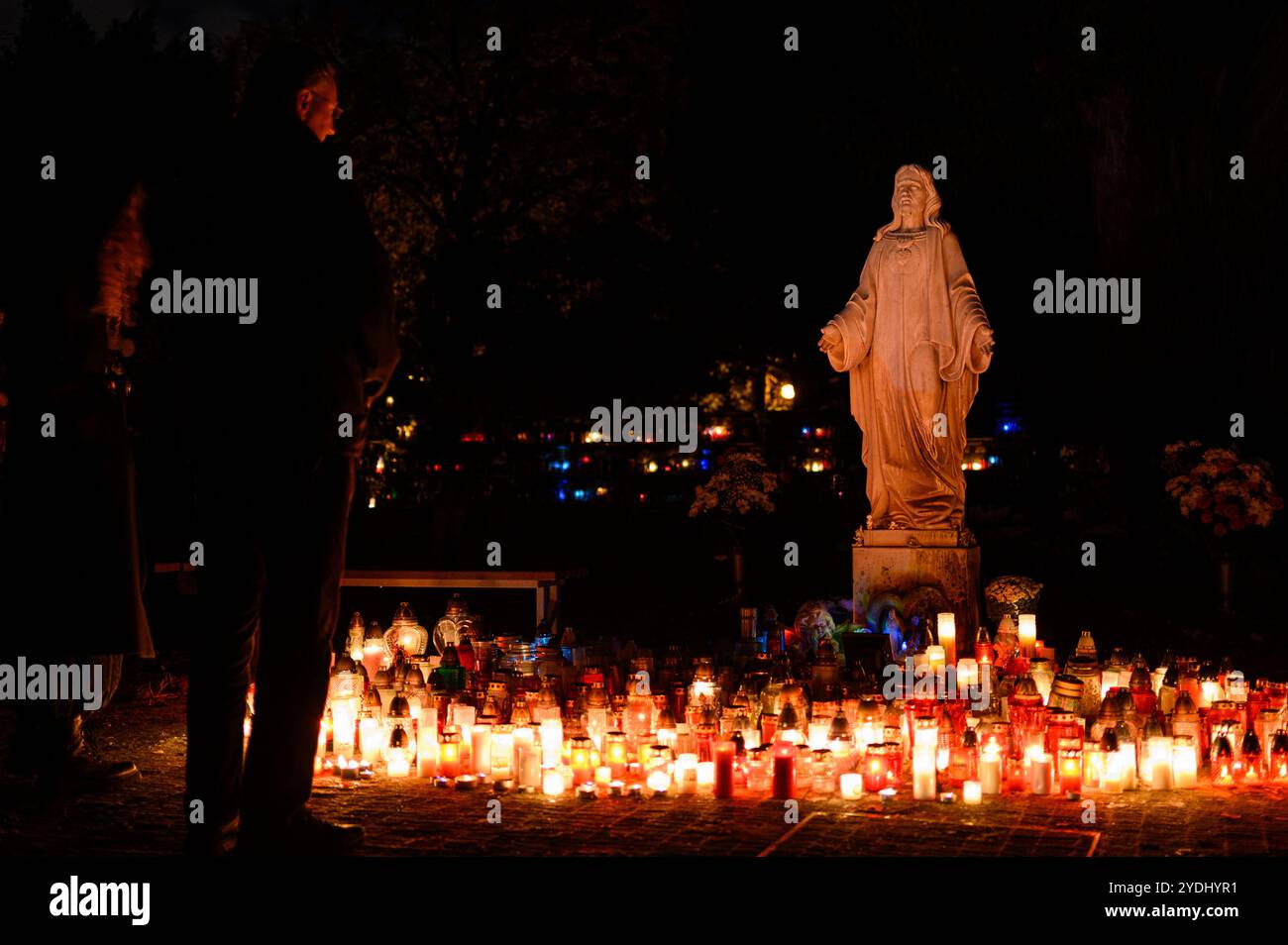 People praying and lighting candles at the Most Sacred Heart of Jesus ...