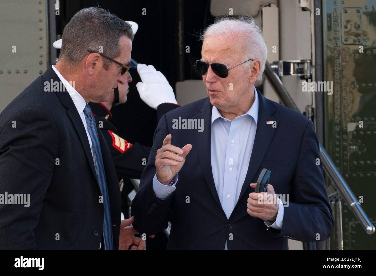 President Joe Biden, right, talks to a Secret Service agent as he ...