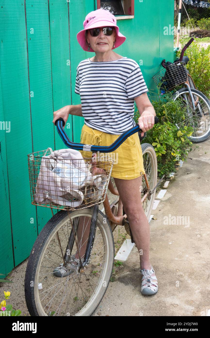 A woman, 72, with a bike in Hopkins, Belize Stock Photo - Alamy