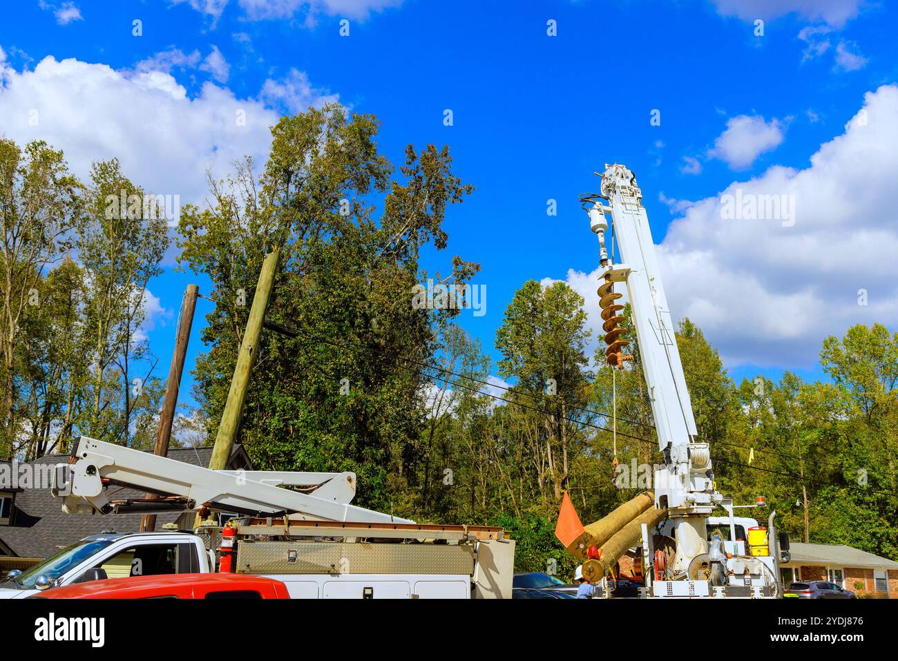 Utility maintenance is progress with technician on lift power lines ...