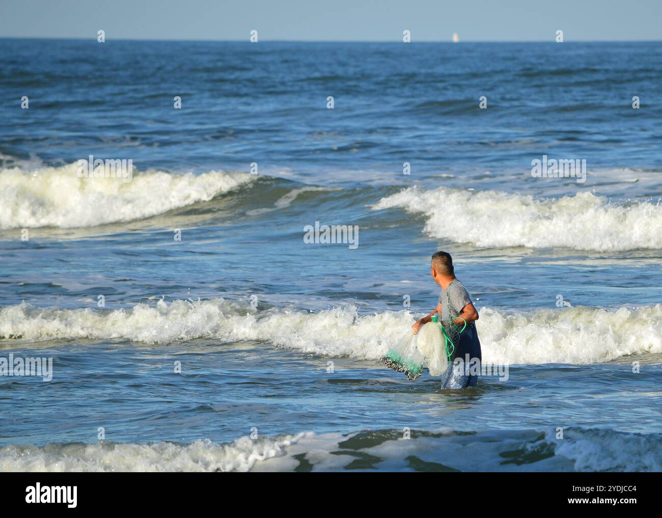 A net fisherman in the surf at golden hour, crashing waves in the ...