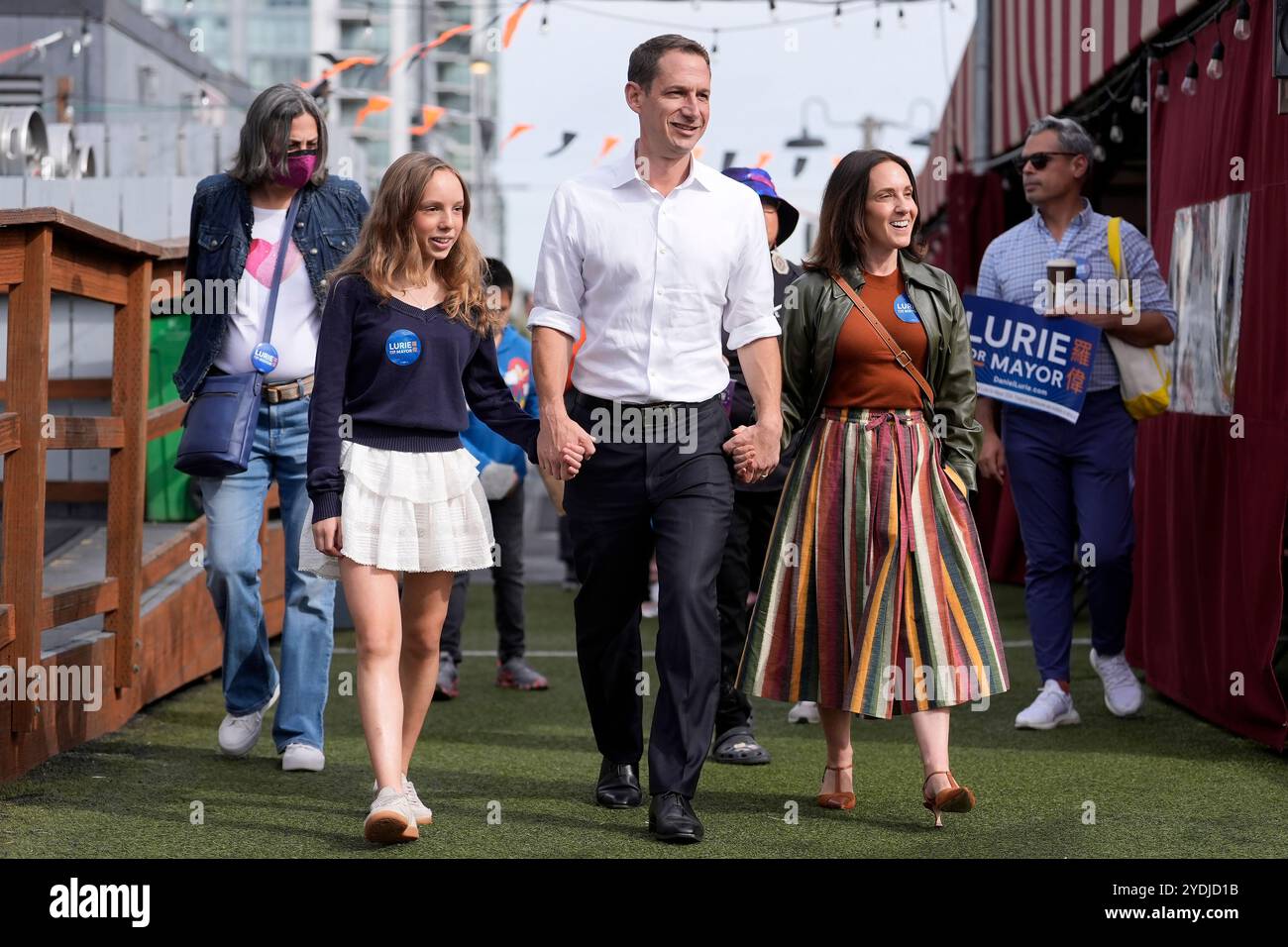 San Francisco mayoral candidate Daniel Lurie, middle, walks with his ...