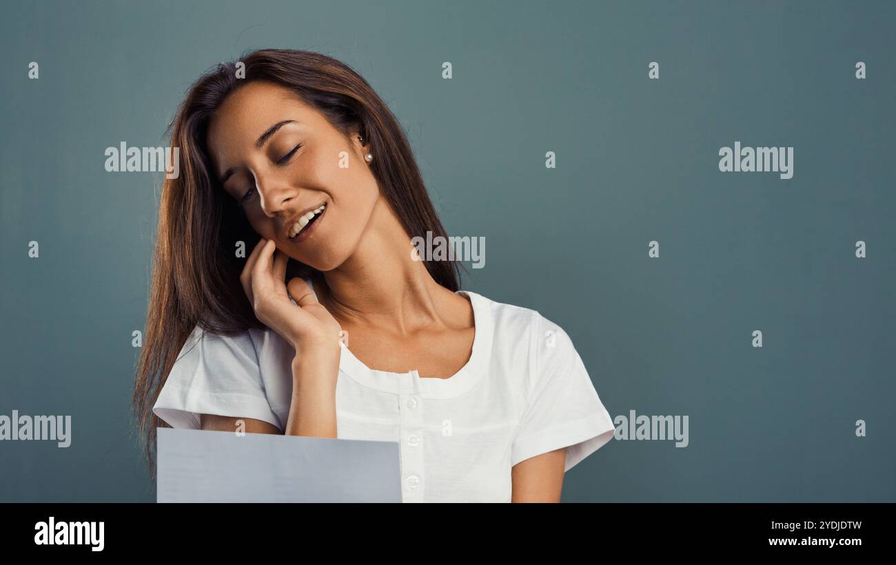 Woman closed eyes smiles holding hi-res stock photography and images ...