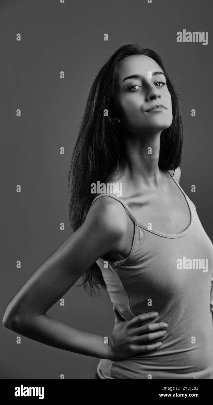 Confident young woman in black and white portrait, standing with hand ...