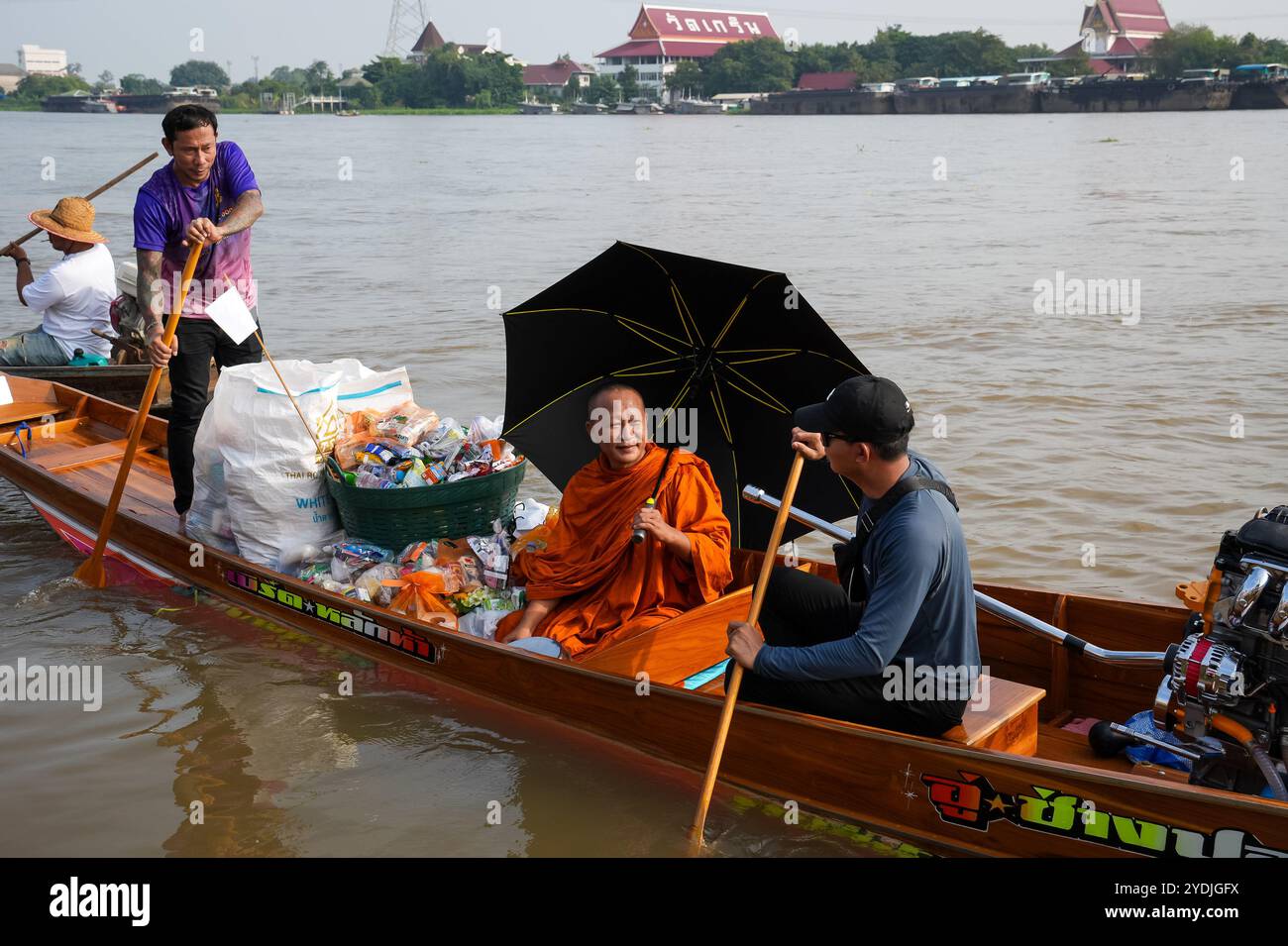 Thailand. 25th Oct, 2024. A monk is seen sitting on a rowboat with an ...