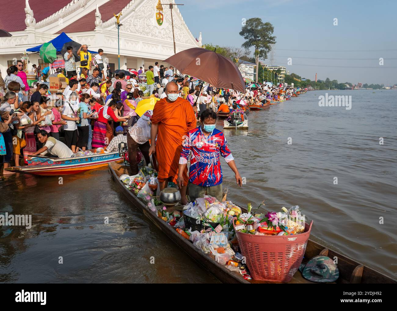 A large view of rowboats full of offerings, with monks inside receiving ...