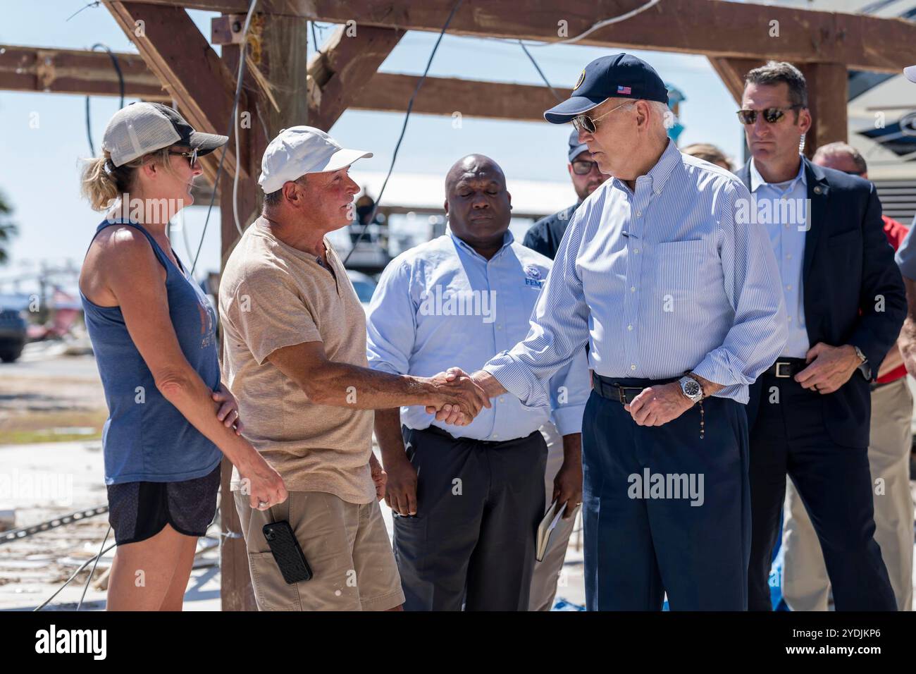 President Joe Biden meets with a family a surveys the damage of their ...