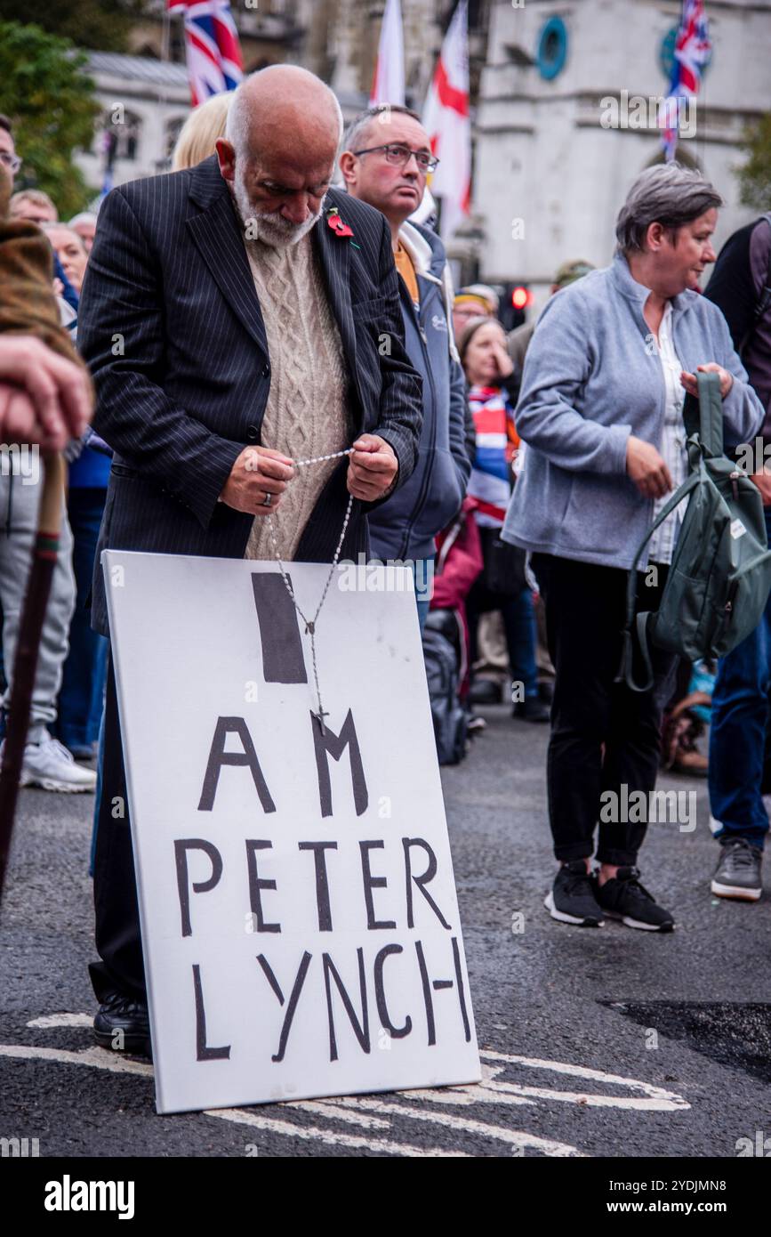 A protestor holds a placard during the demonstration. Tommy Robinson ...