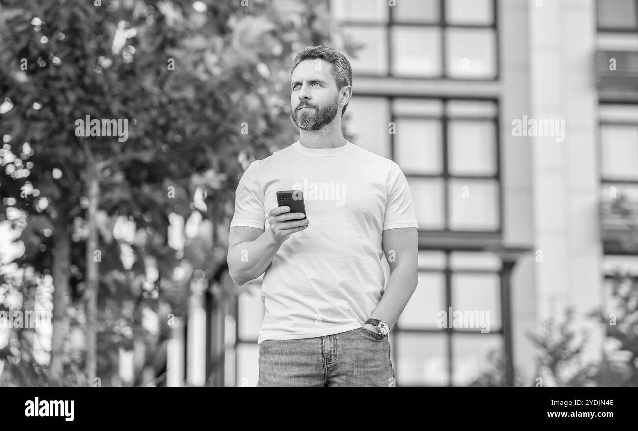 man messaging on phone outdoor. man messaging on phone in the street ...