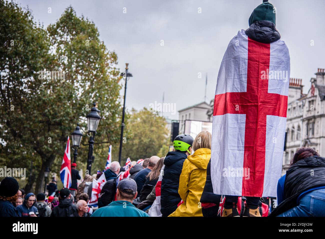 A protestor is wrapped with the cross of England during the ...