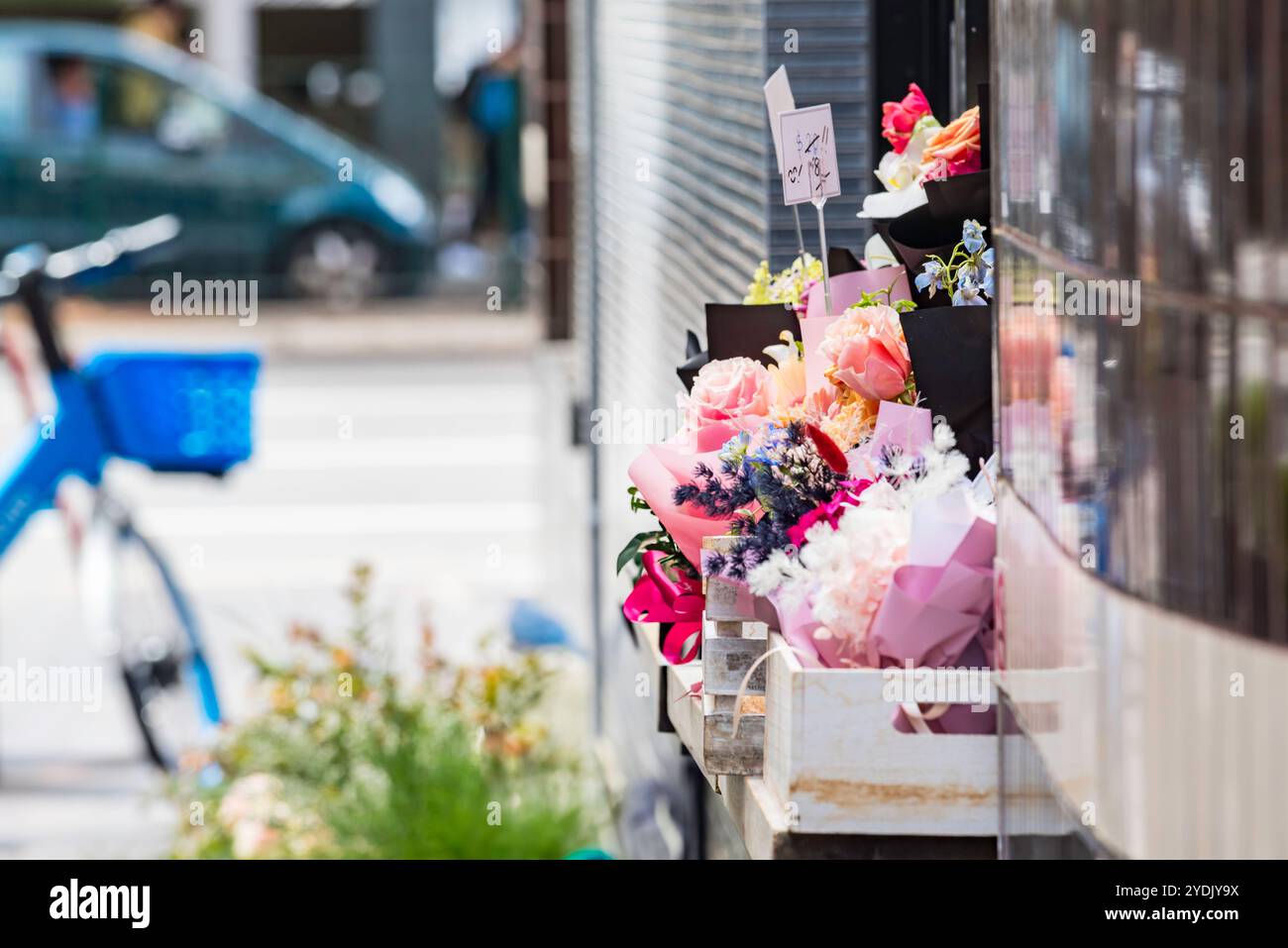 Cut flowers, flower arrangements for sale on a window ledge of a shop ...