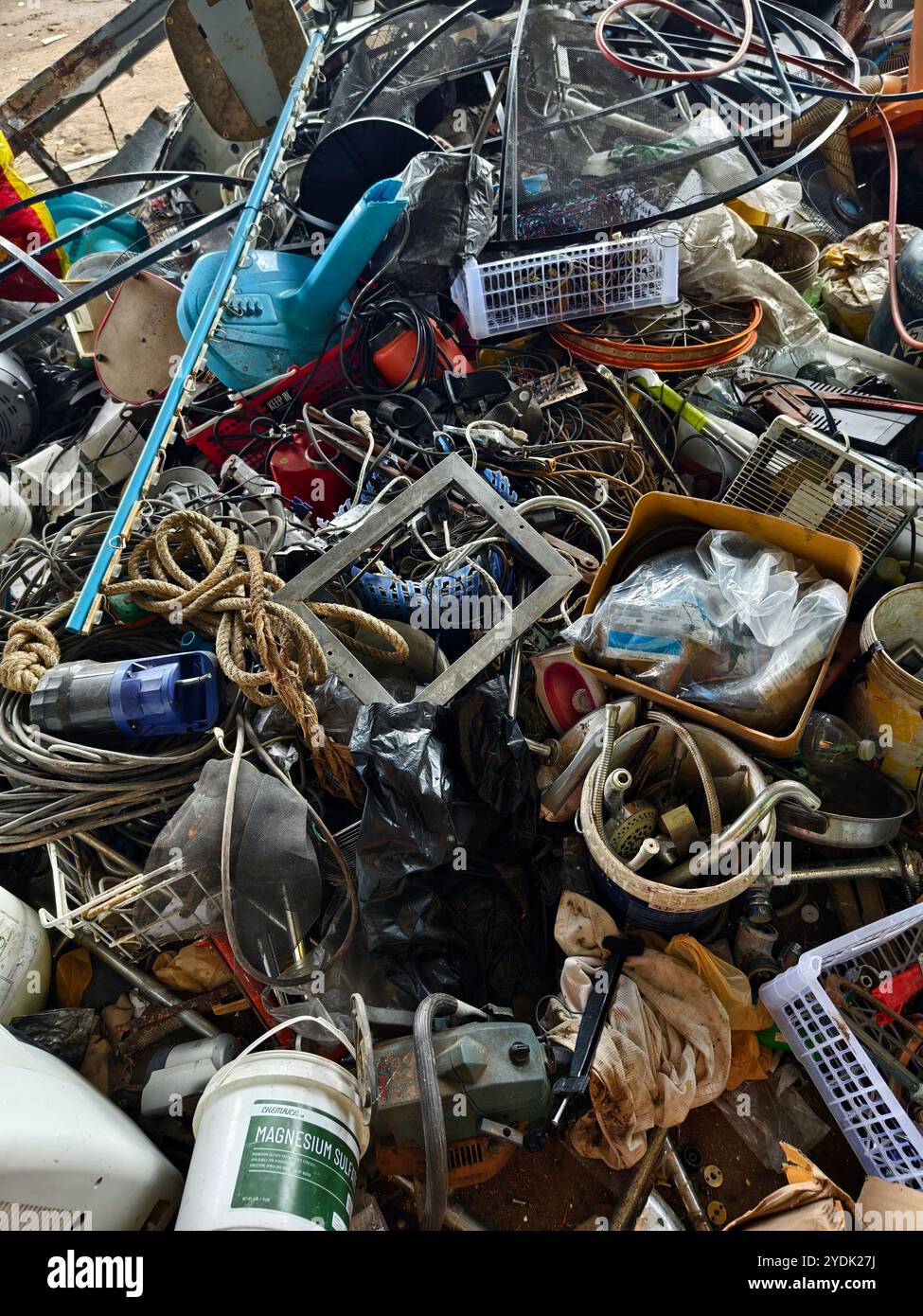 A pile of garbage with a bucket, rope, bottles, and other items at a ...