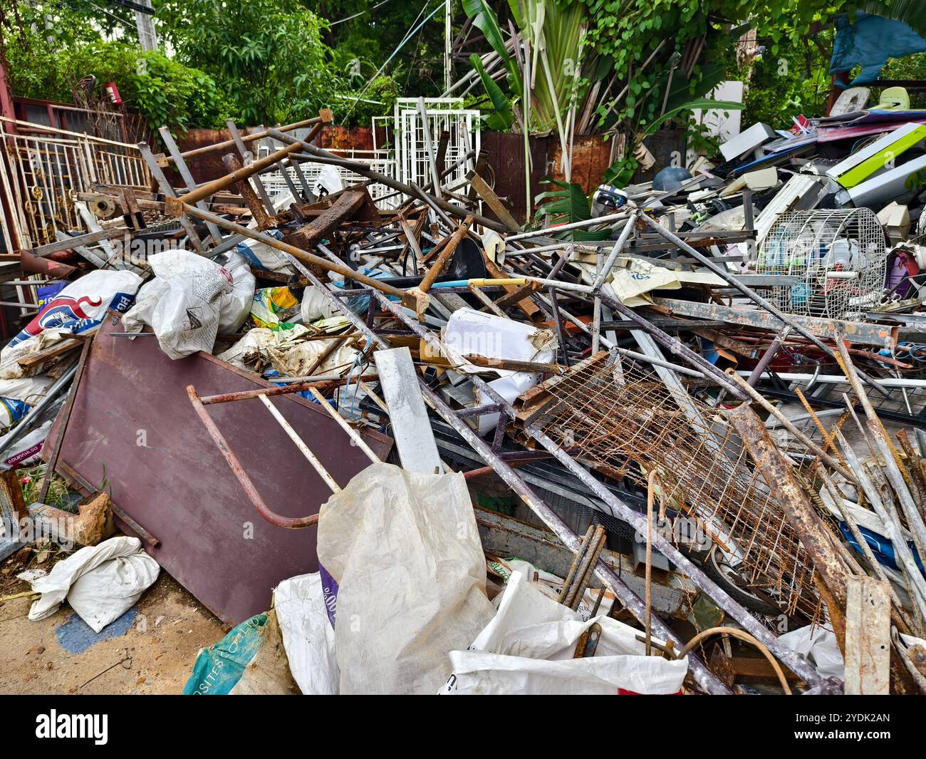 A pile of garbage with a bucket, rope, bottles, and other items at a ...