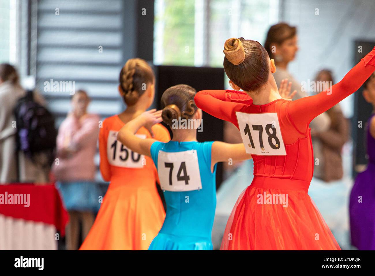 backs of heads happy girls with a hairstyledances solo at the ...