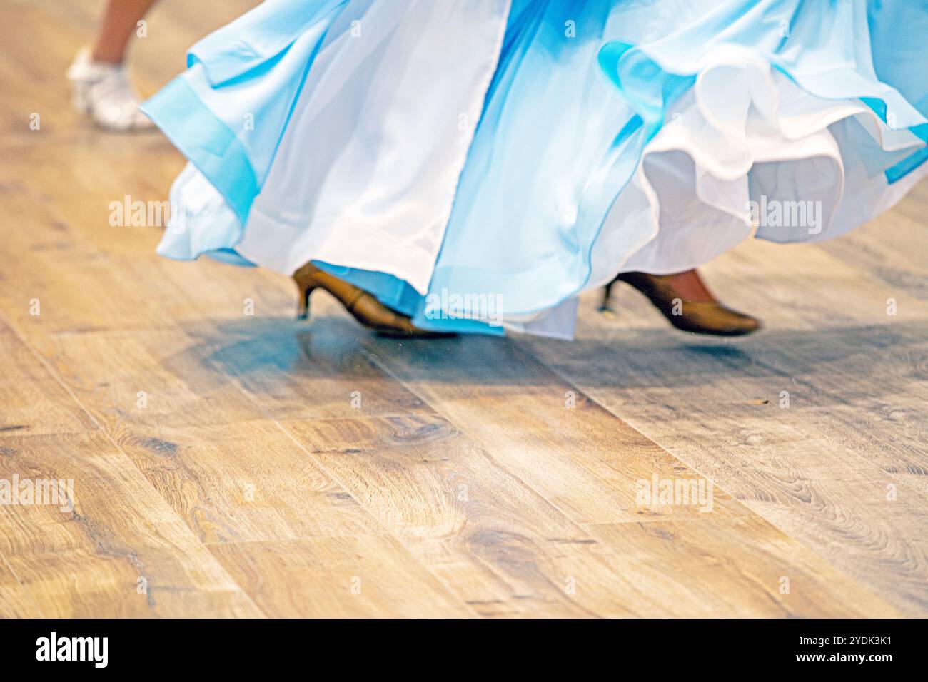girl in a light blue dance dress dances on the dance floor at the ...