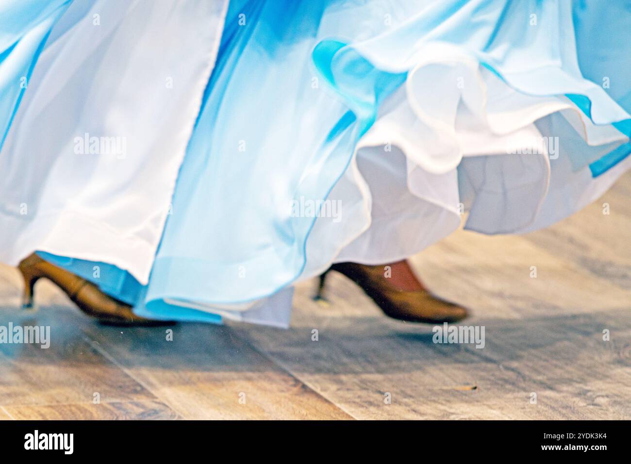 girl in a light blue dance dress dances on the dance floor at the ...