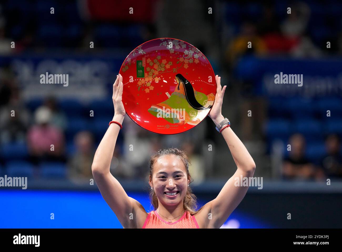 China's Zheng Qinwen poses with her trophy after winning the Pan ...