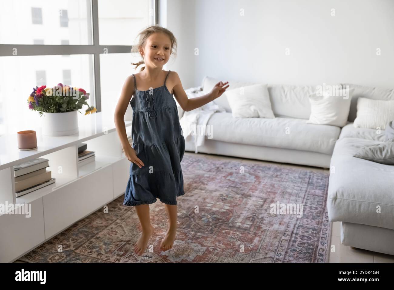 Happy hyperactive girl dancing and jumping to music at home Stock Photo ...