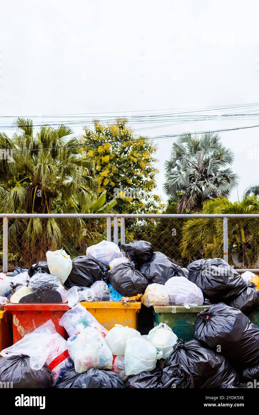 several trash bins overflowing with garbage bags. The image captures ...