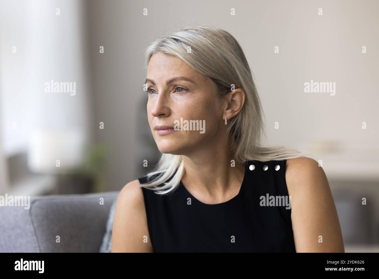 Headshot thoughtful aged lady sit on couch look aside ponder Stock ...