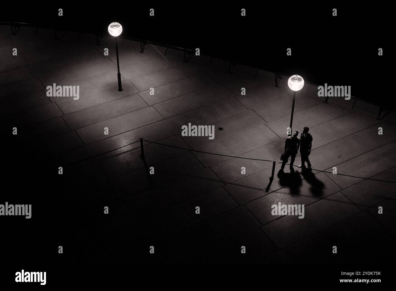 Pools of light on the he Sydney Opera House broadwalk at night seen ...