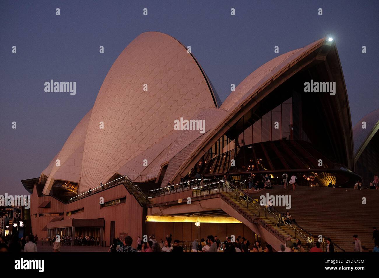 The tall sails of the Sydney Opera House Concert hall at dusk with ...