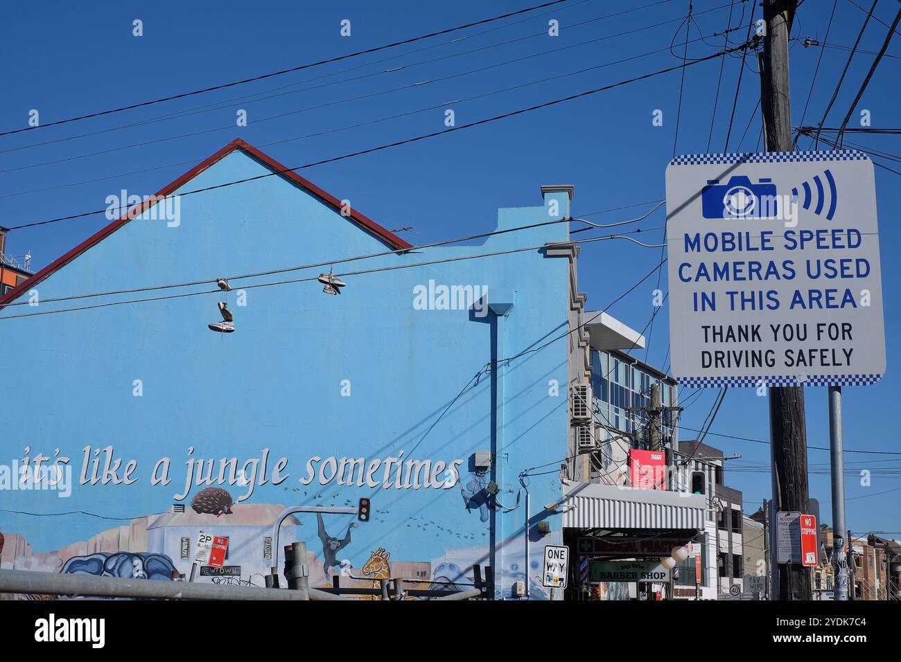 Mural, buildings and streetscape along Enmore Road, in inner city ...