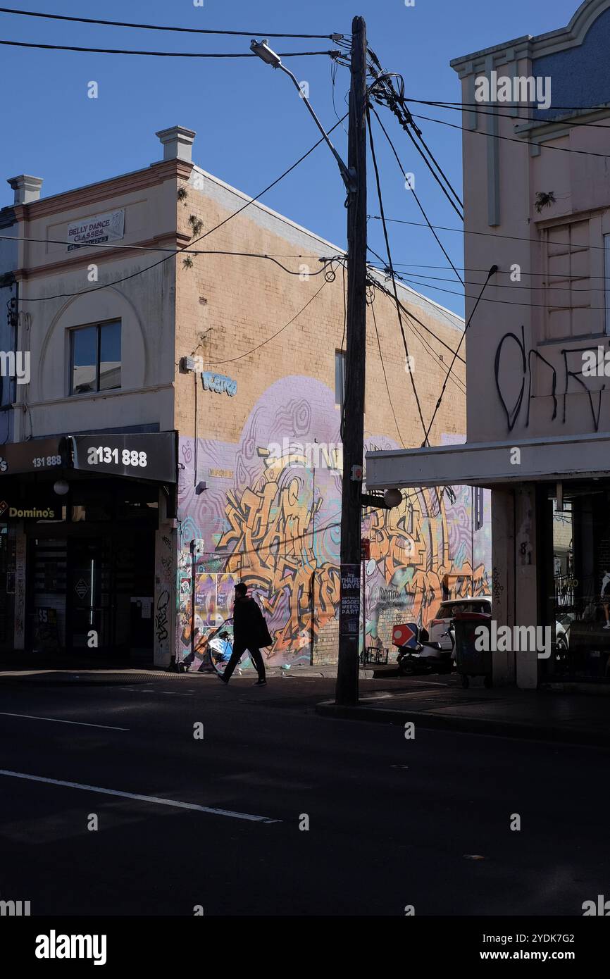 Buildings and streetscape along Enmore Road, in inner city Sydney signs ...