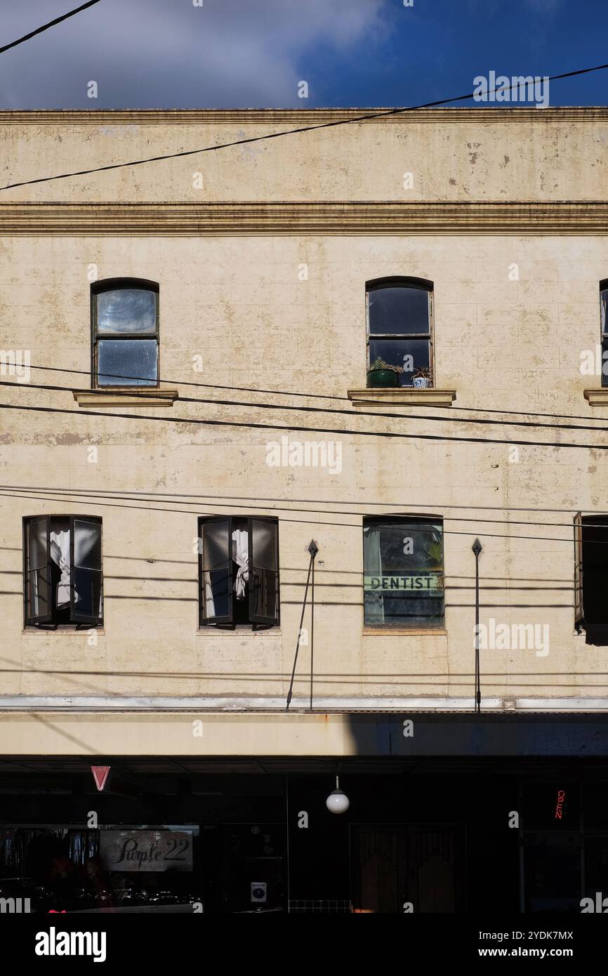 Buildings and streetscape along Enmore Road, in inner city Sydney signs ...