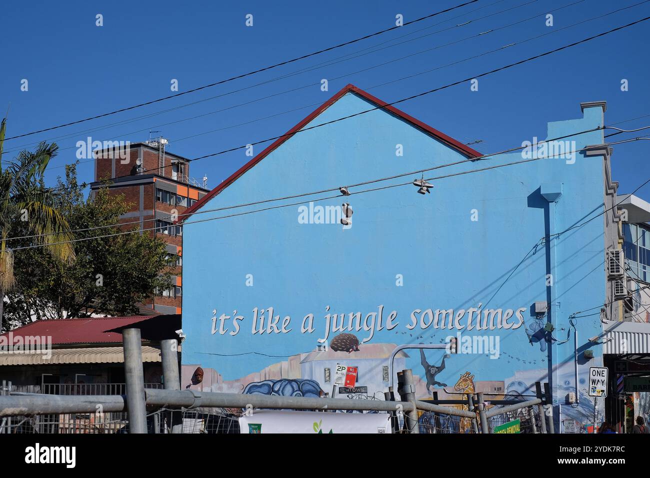 Buildings and streetscape along Enmore Road, in inner city Sydney signs ...