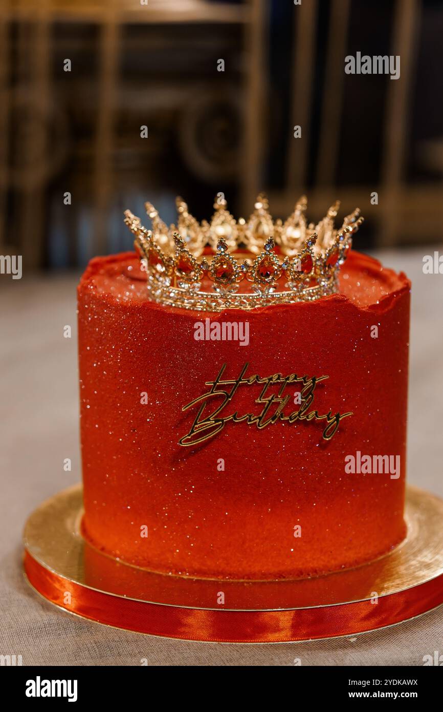 Elegant Red Birthday Cake with Crown Decoration Stock Photo - Alamy