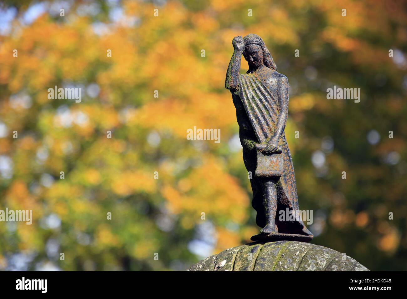 Sad female messenger figure on old tombstone, bokeh background with ...