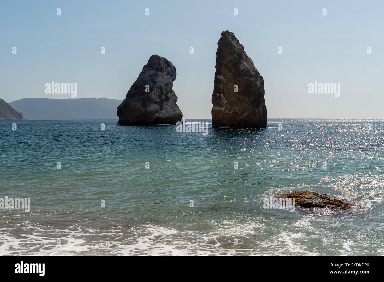 Rocks Sea Coastline - Two tall rocky formations stand in the ocean off ...
