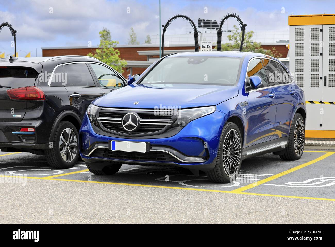 Blue Mercedes-Benz EQC 4-matic electric SUV car charging battery at ...